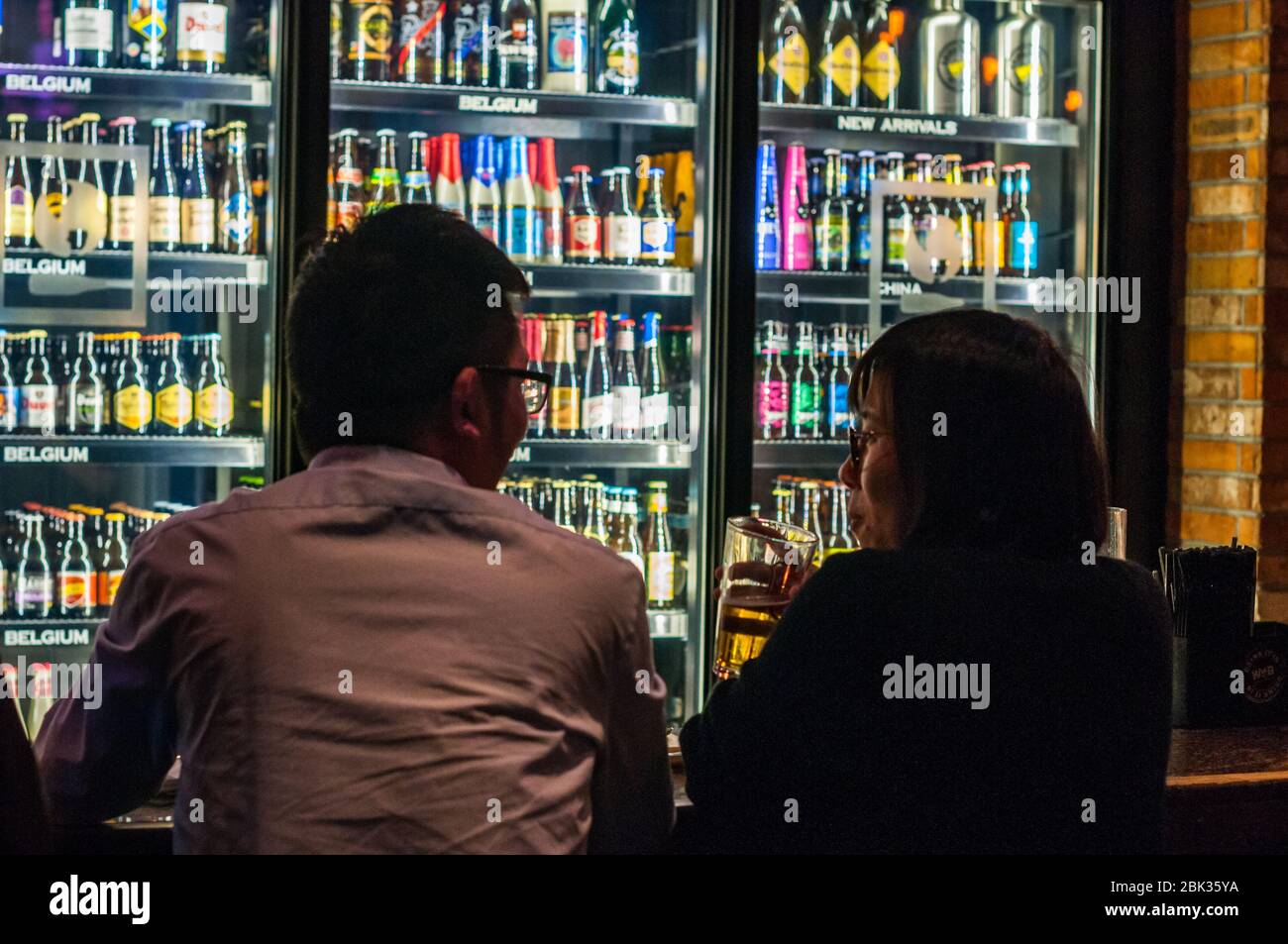 Customers enjoy a talk over a beer at World of Beer (WOB) on Shanghai's ...