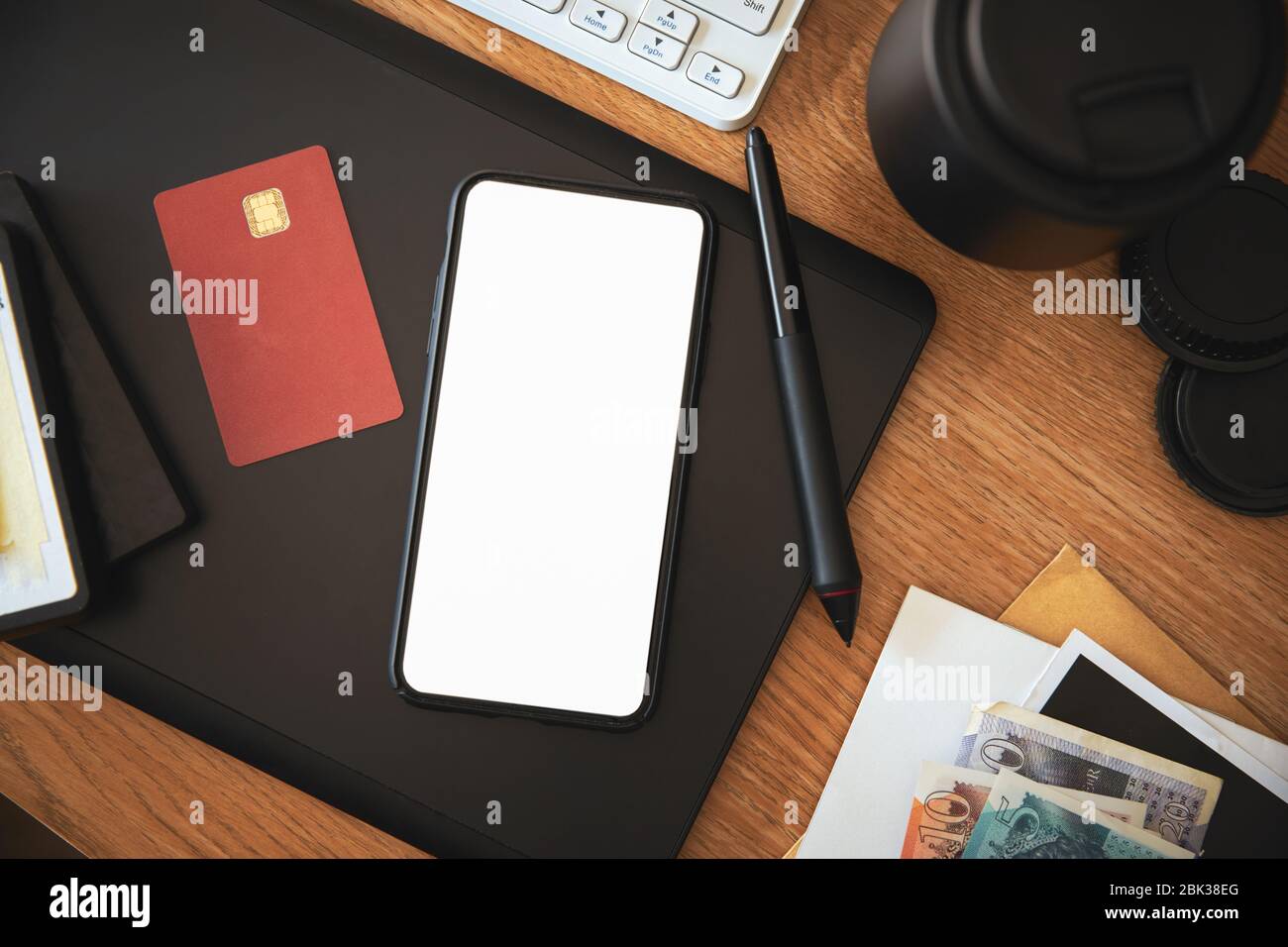Smart phone on desk of creative with blank white screen Stock Photo - Alamy