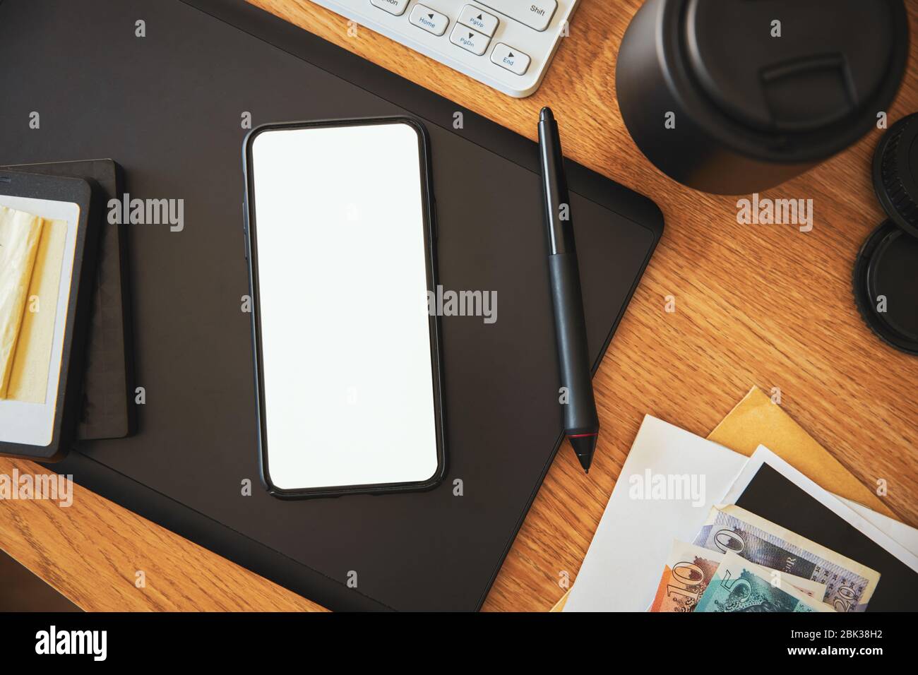 Smart phone on desk of creative with blank white screen Stock Photo - Alamy