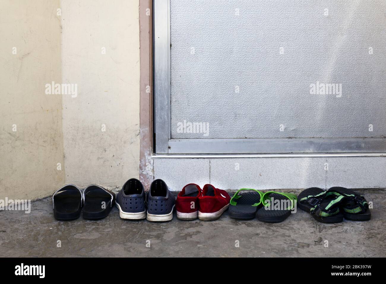 Photo of shoes and slippers on the doorway of a house Stock Photo - Alamy