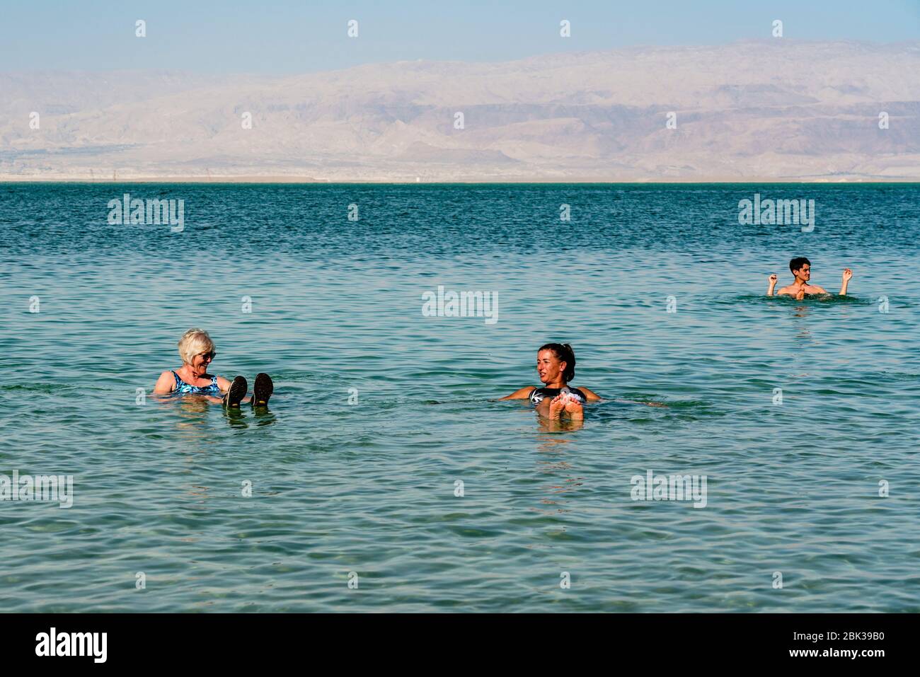 Israel, Ein Bokek, Dead Sea, Visitors relax and float in the warm, bouyant waters of the Dead ...