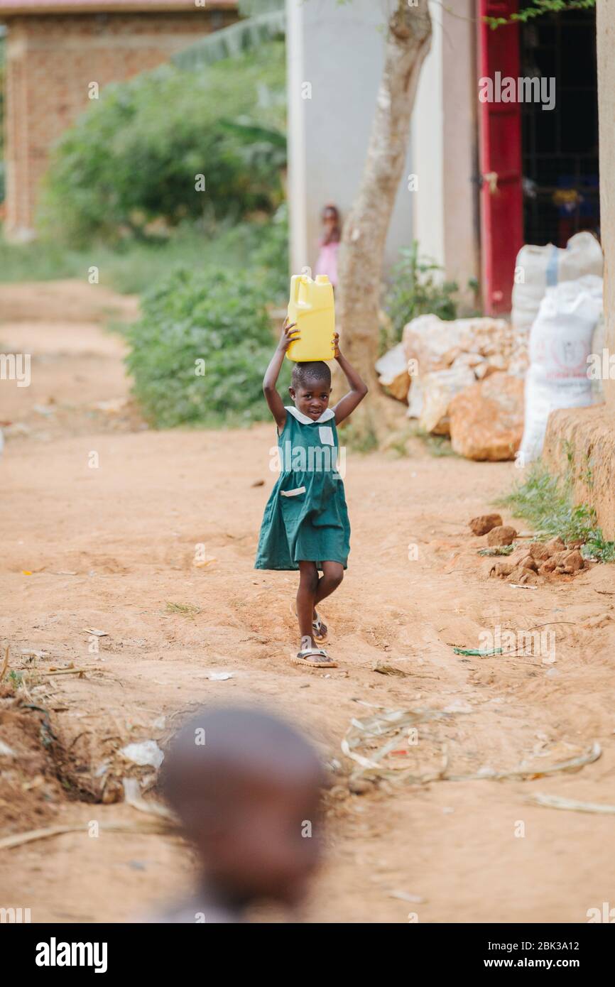 Child carrying water in Uganda, Africa Stock Photo - Alamy