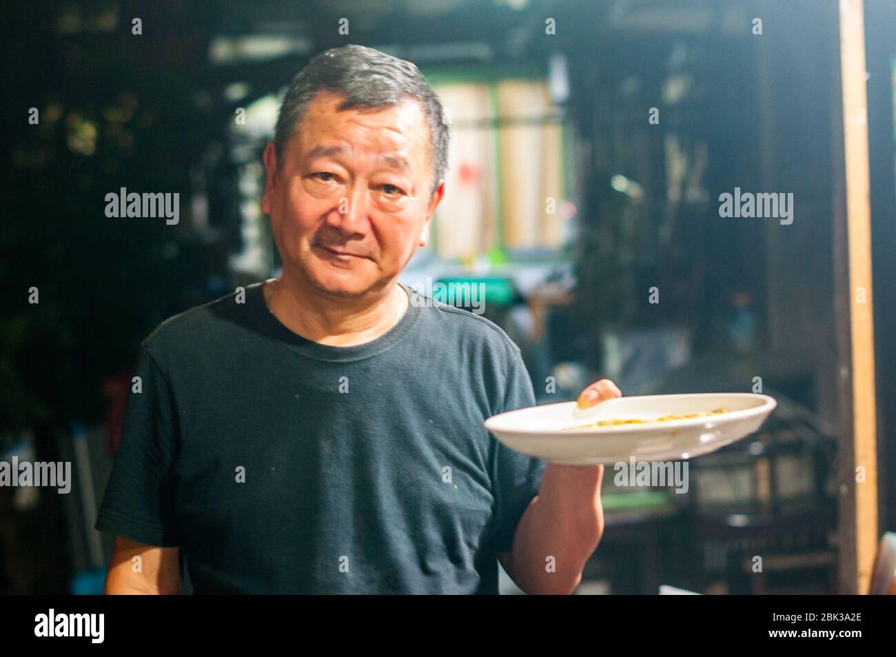 Mr Yu in his open kitchen in a longtang alleyway in Shanghai Stock ...