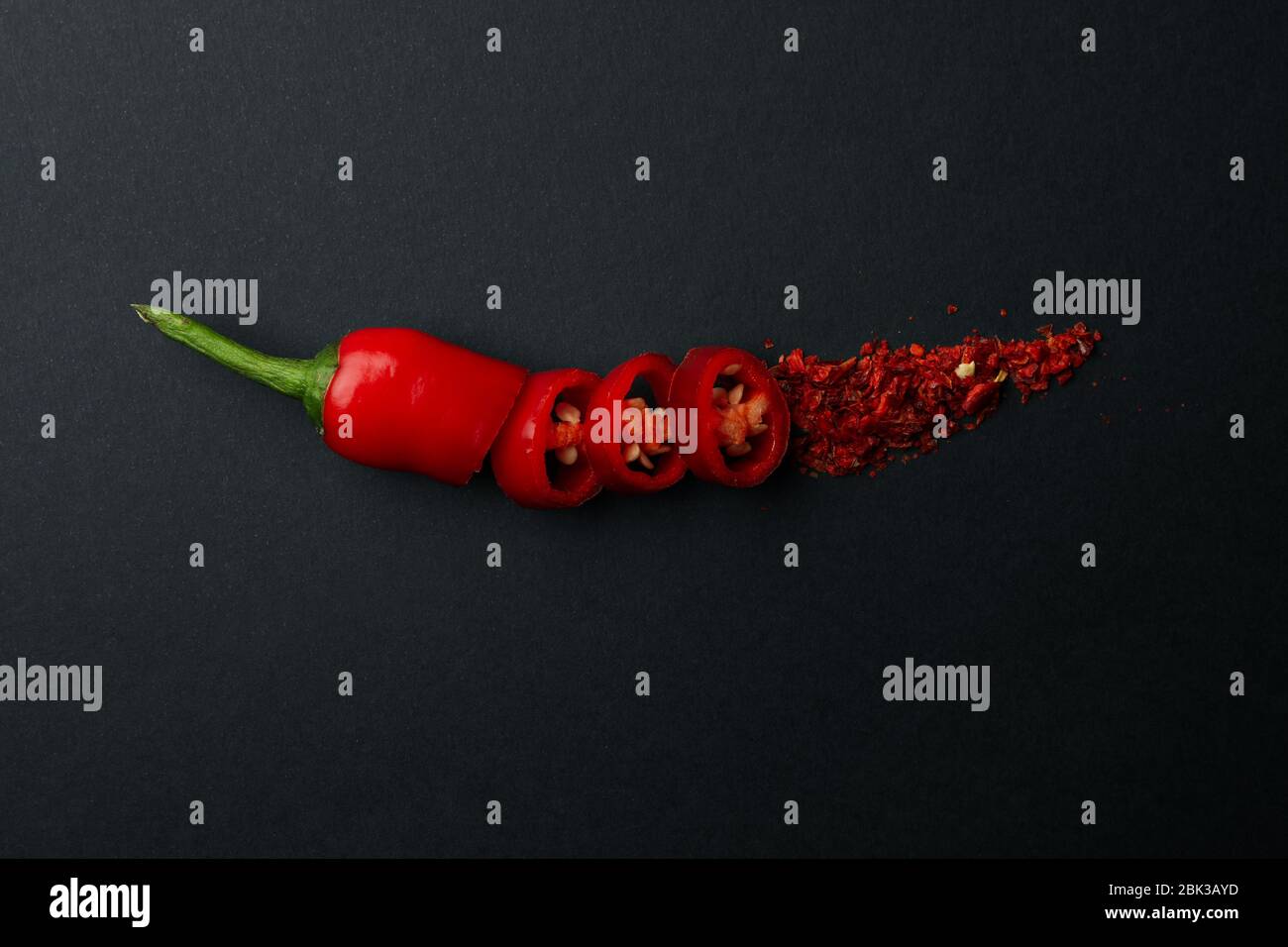 Chopped chilli pepper and spice on black background Stock Photo - Alamy