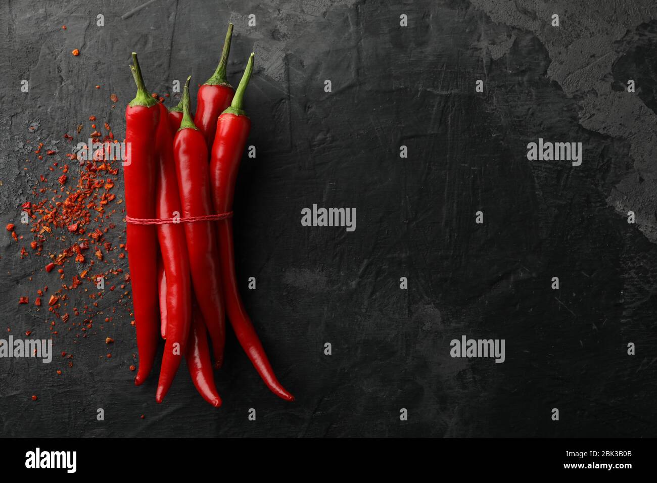 Chilli peppers on black background, top view Stock Photo - Alamy