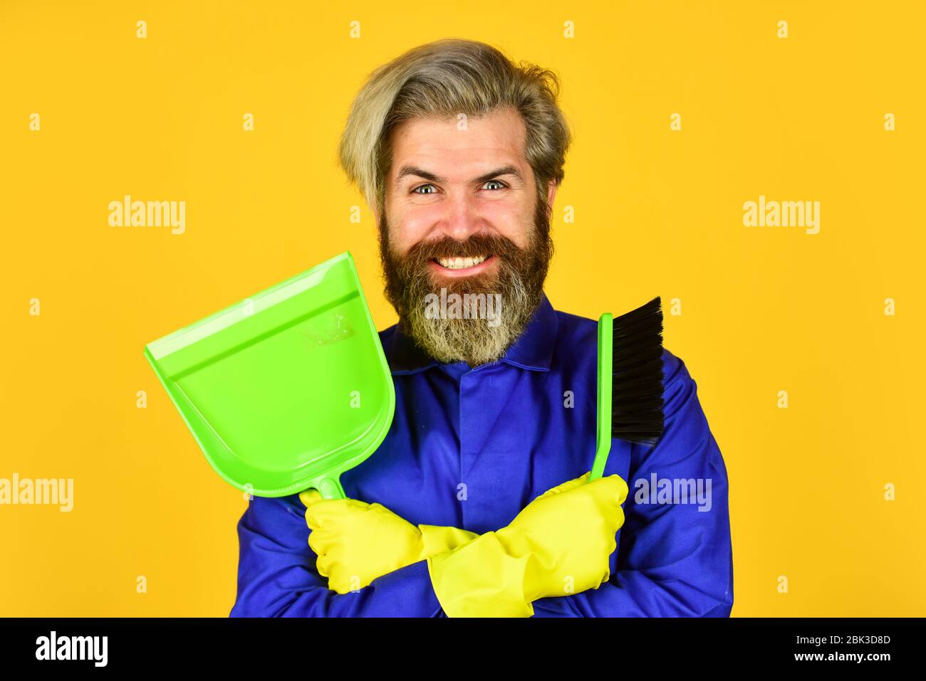 Cleaning day. Janitor professional. Bearded hipster blue uniform with ...