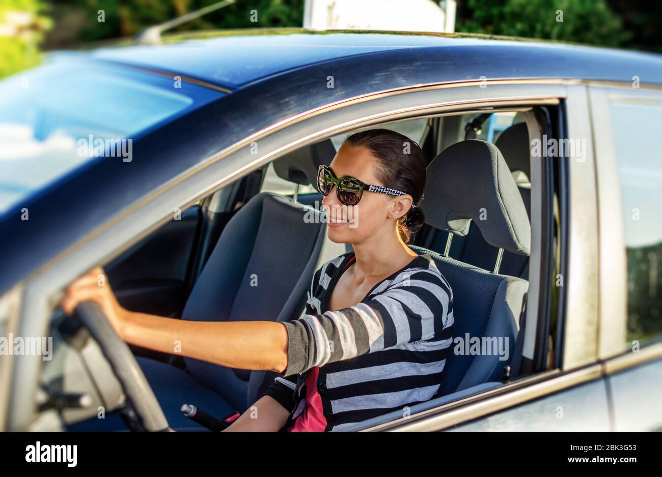 Woman driver driving a car Stock Photo - Alamy