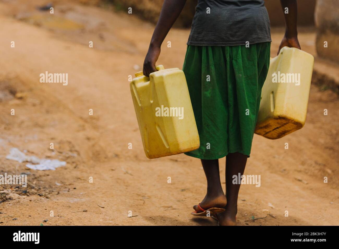 Person carrying water in the city of Entebbe in Uganda, Africa Stock ...