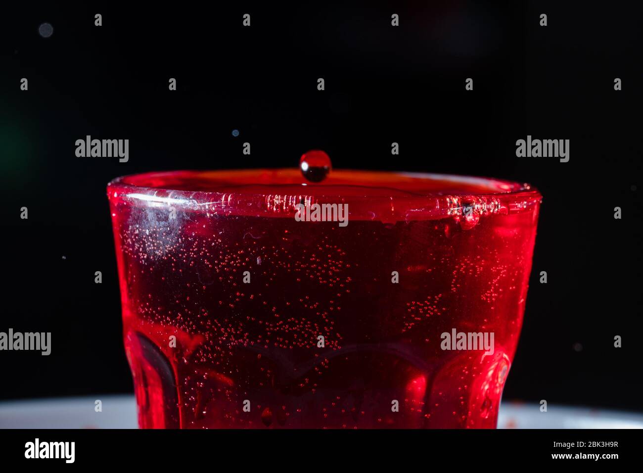 drops of red liquid in glass beaker Stock Photo - Alamy
