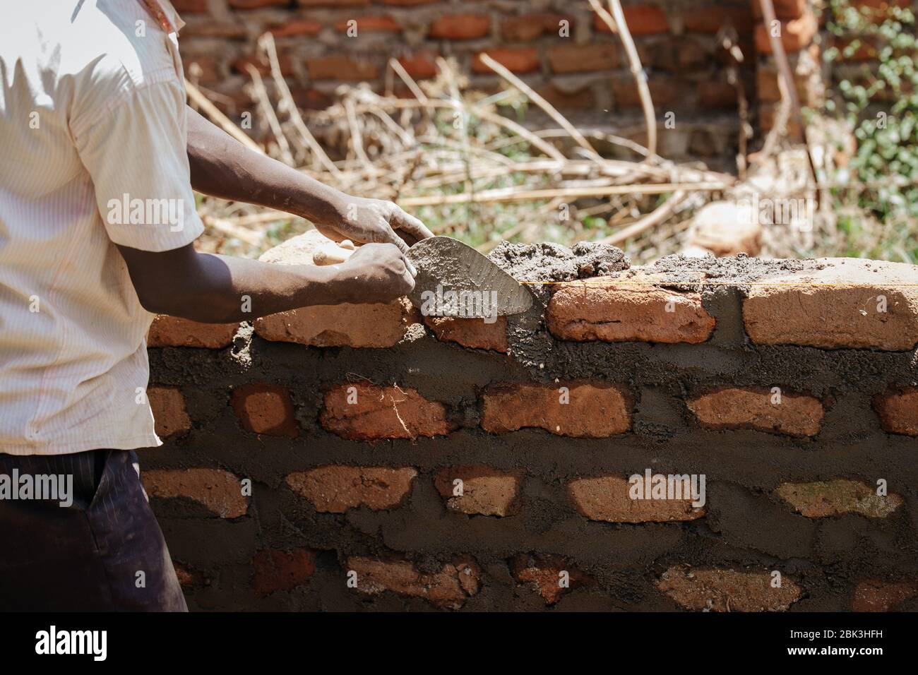 Man building a brick wall in Uganda, Africa Stock Photo - Alamy