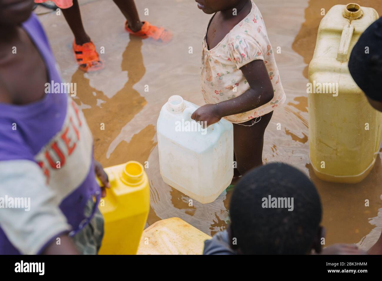 Children getting water at a well in Entebbe, Uganda Stock Photo - Alamy