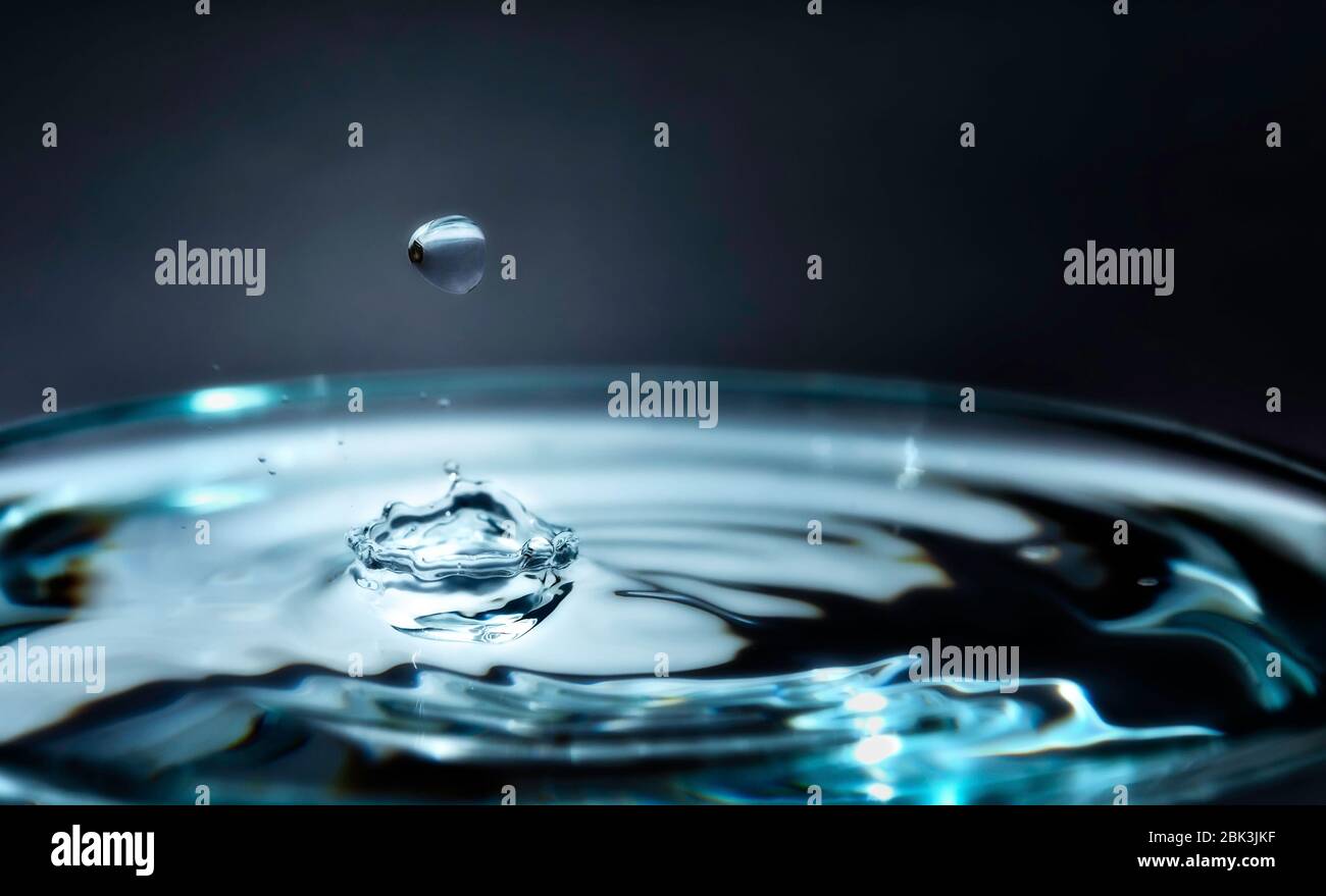 Water drops splash in a glass bowl of water below, United States, color ...