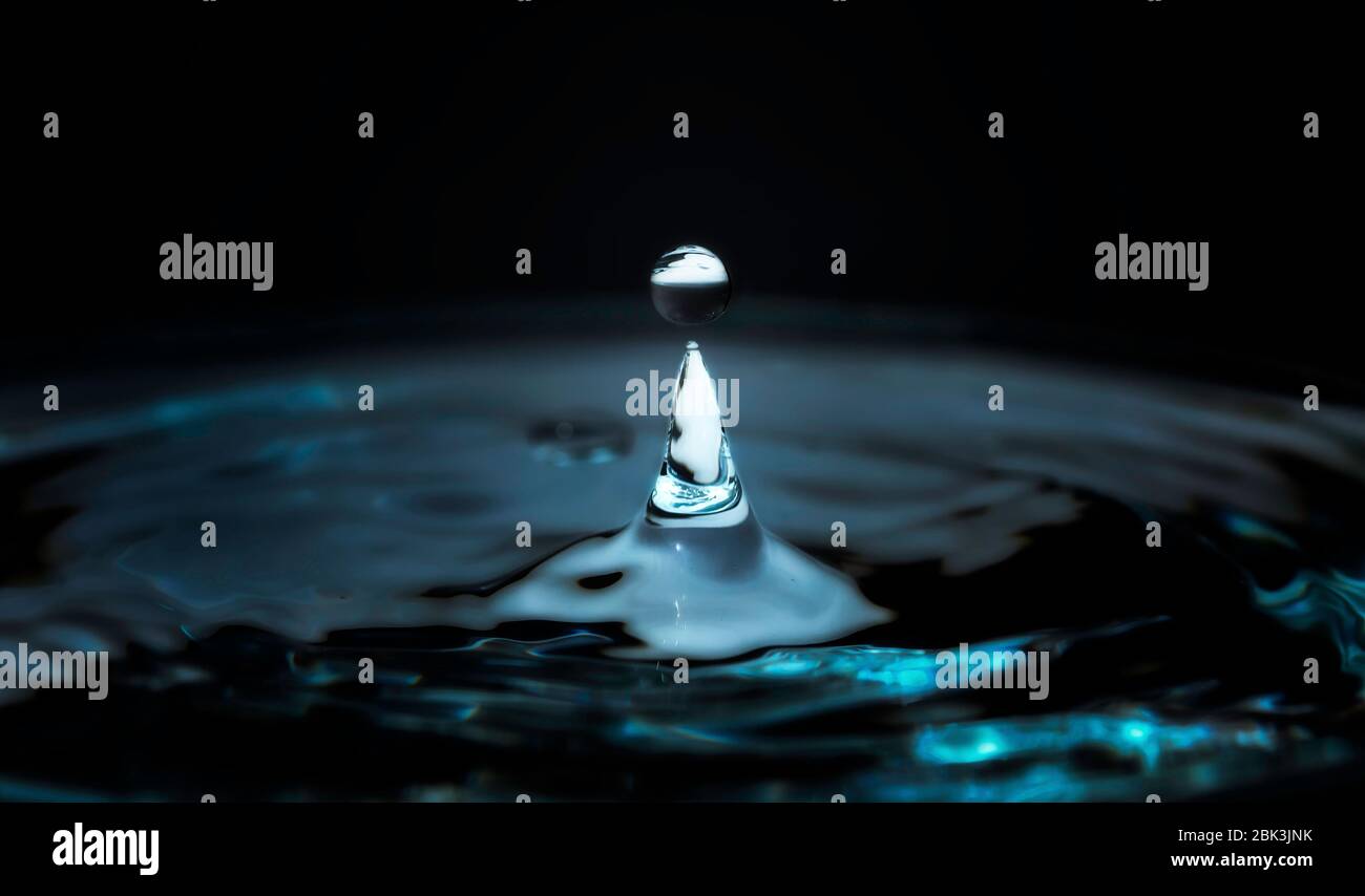 Water drops splash in a glass bowl of water below, United States, color ...