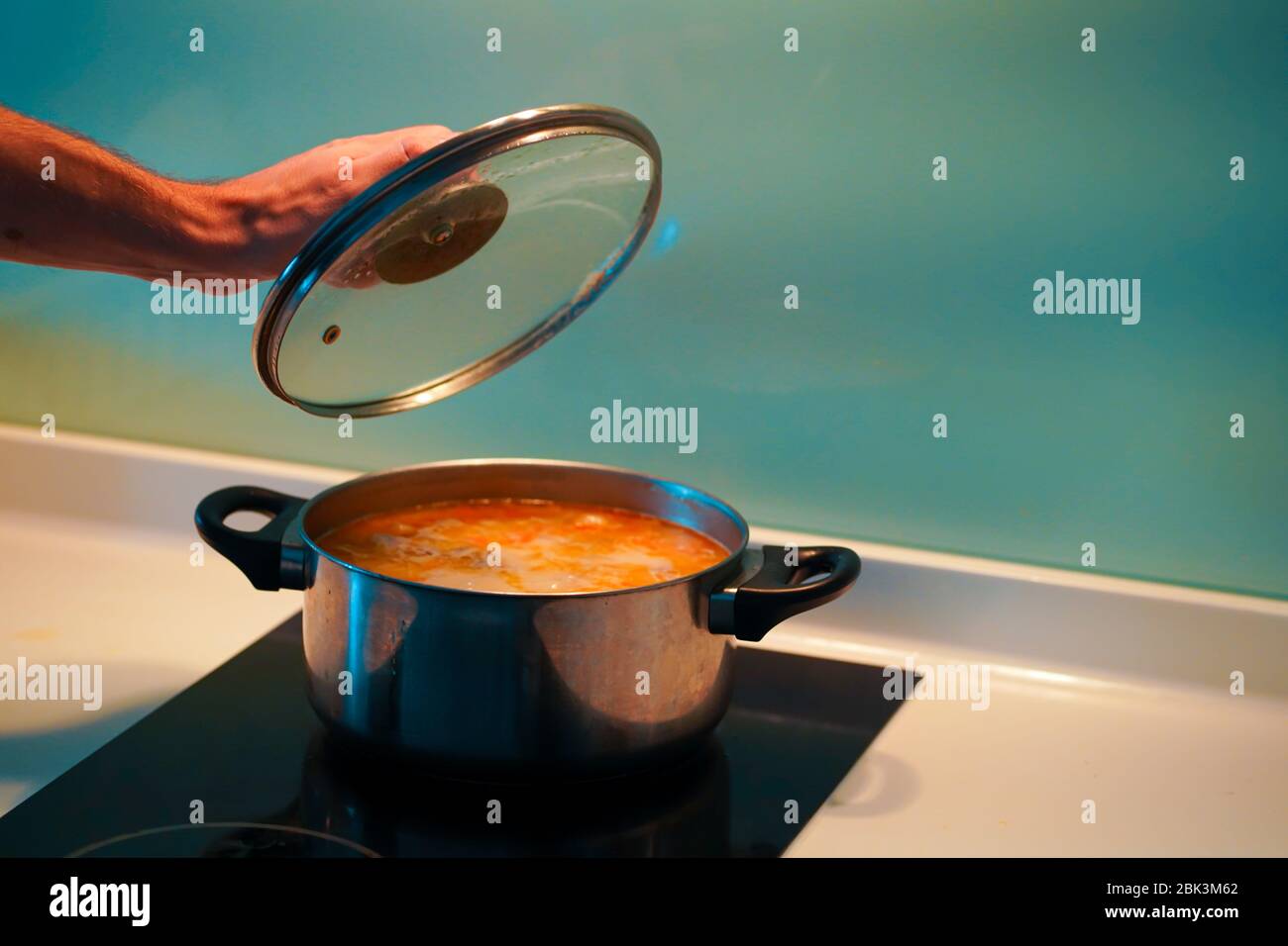 Cooking soup in a pan on an induction stove Stock Photo - Alamy