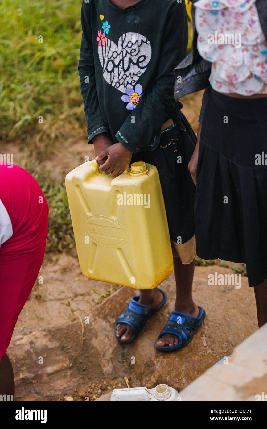 People getting water at a well with water cans Stock Photo - Alamy