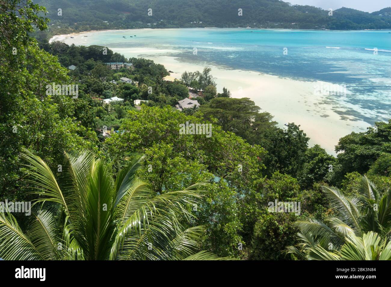 View looking out over the Seychelles Beach Bay with the tropical forest ...
