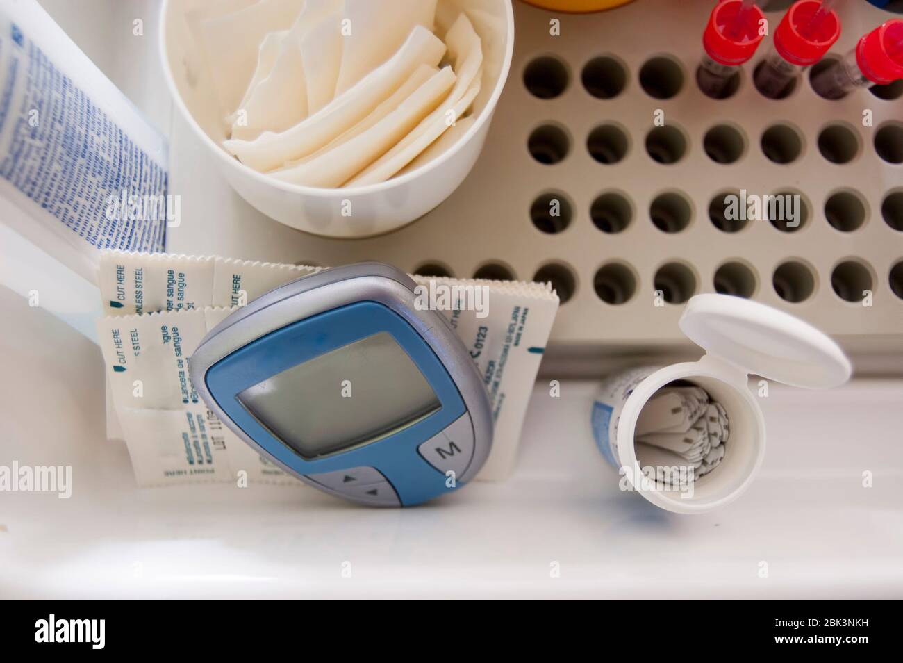 A diagnostic test strip for measuring blood sugar is inserted into a ...