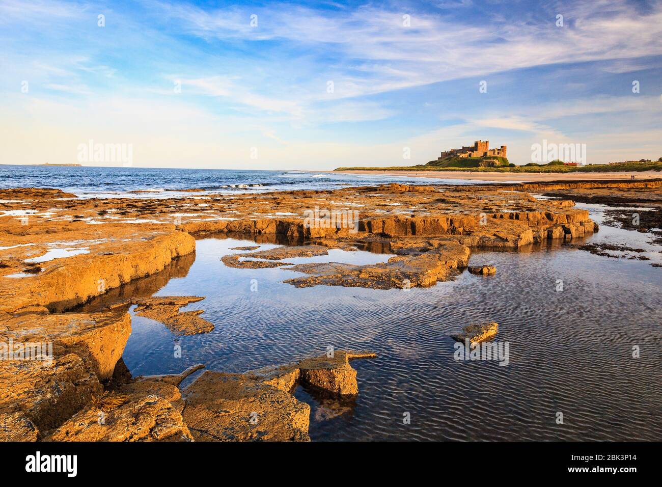 Bamburgh Castle across Harkess Rocks, Northumberland, England Stock ...