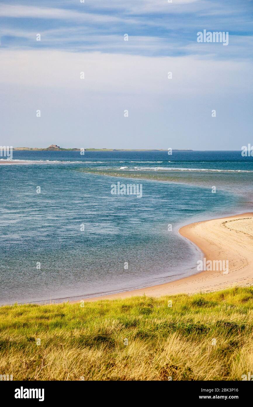 High tide at Budle Point on Budle Bay with Lindisfarne island on the ...