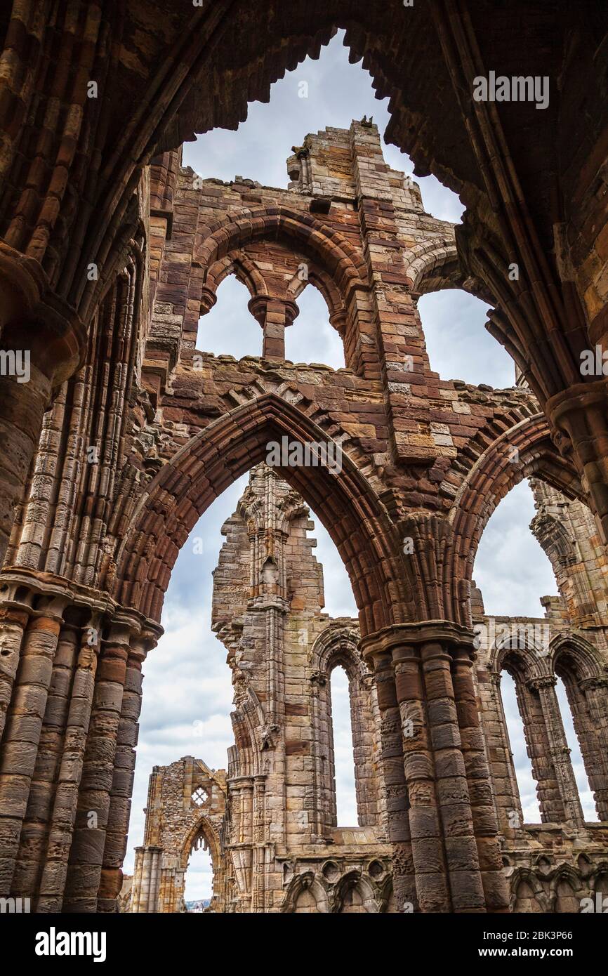The ruined arches and columns of Whitby Abbey in Yorkshire, England ...