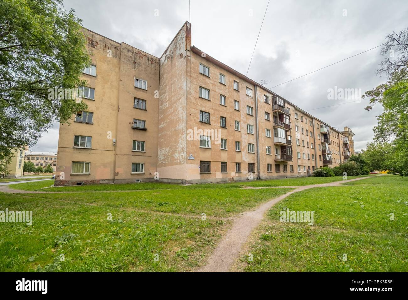 Street view of old multistory apartment house with balconies, cheap ...