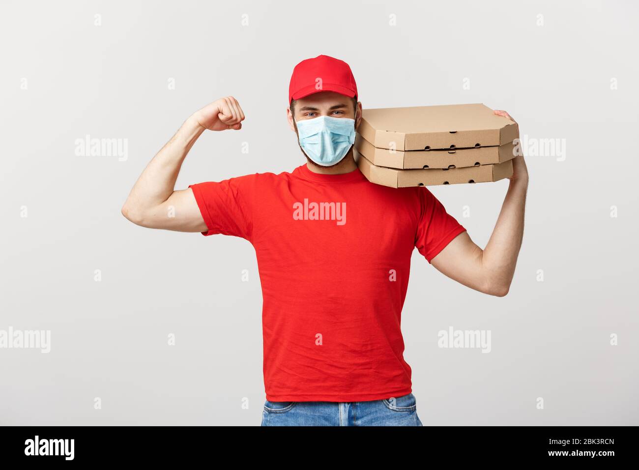 Delivery Concept - Portrait of Strong handsome delivery man flexing his ...