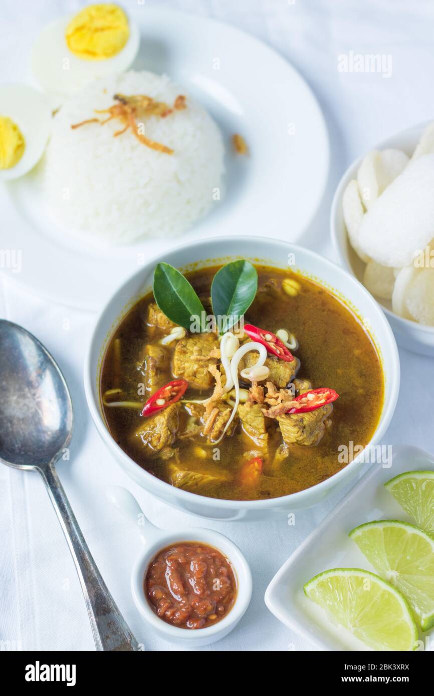Rawon is traditional Indonesian beef black soup. Served with steam rice ...