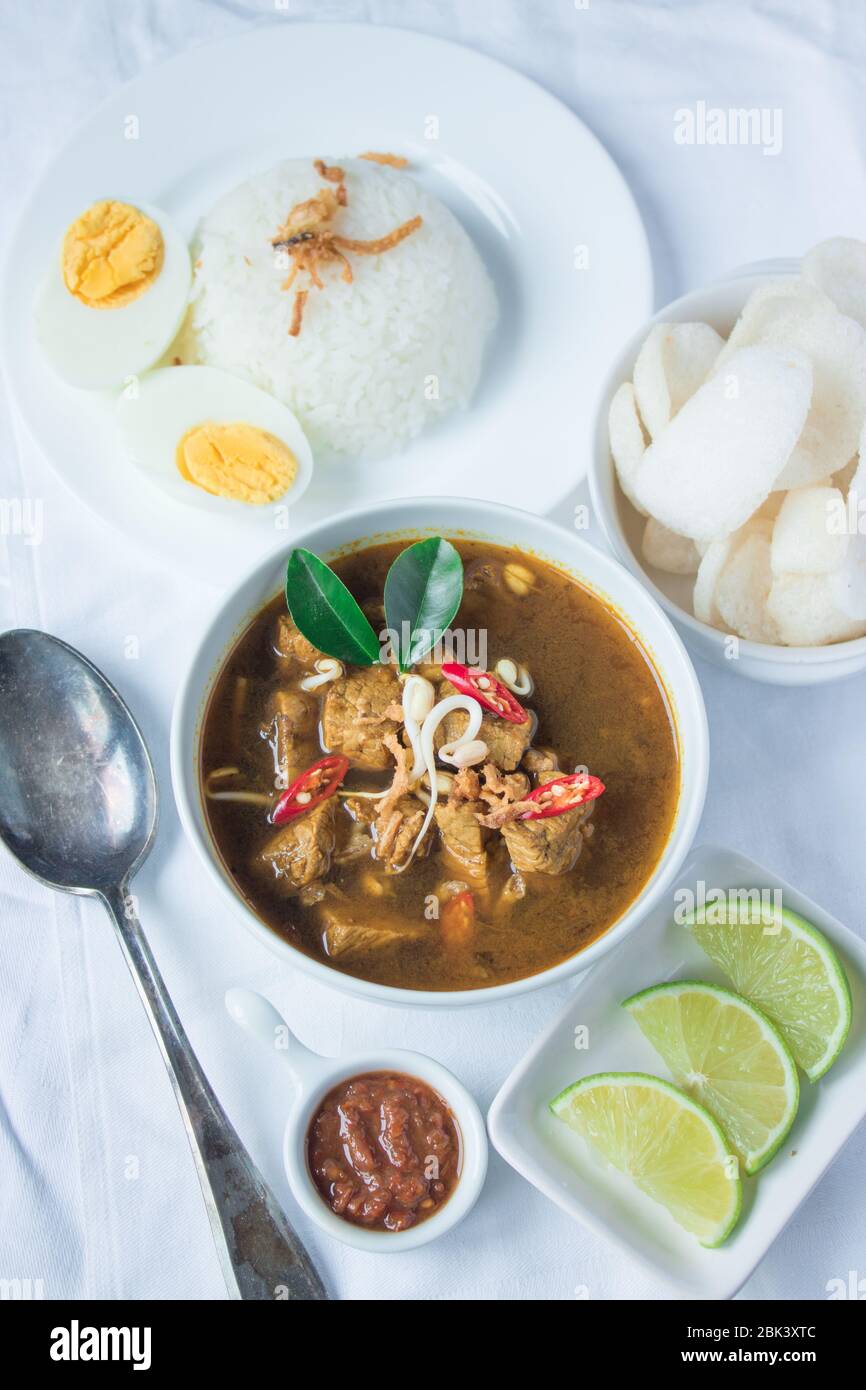Rawon is traditional Indonesian beef black soup. Served with steam rice ...