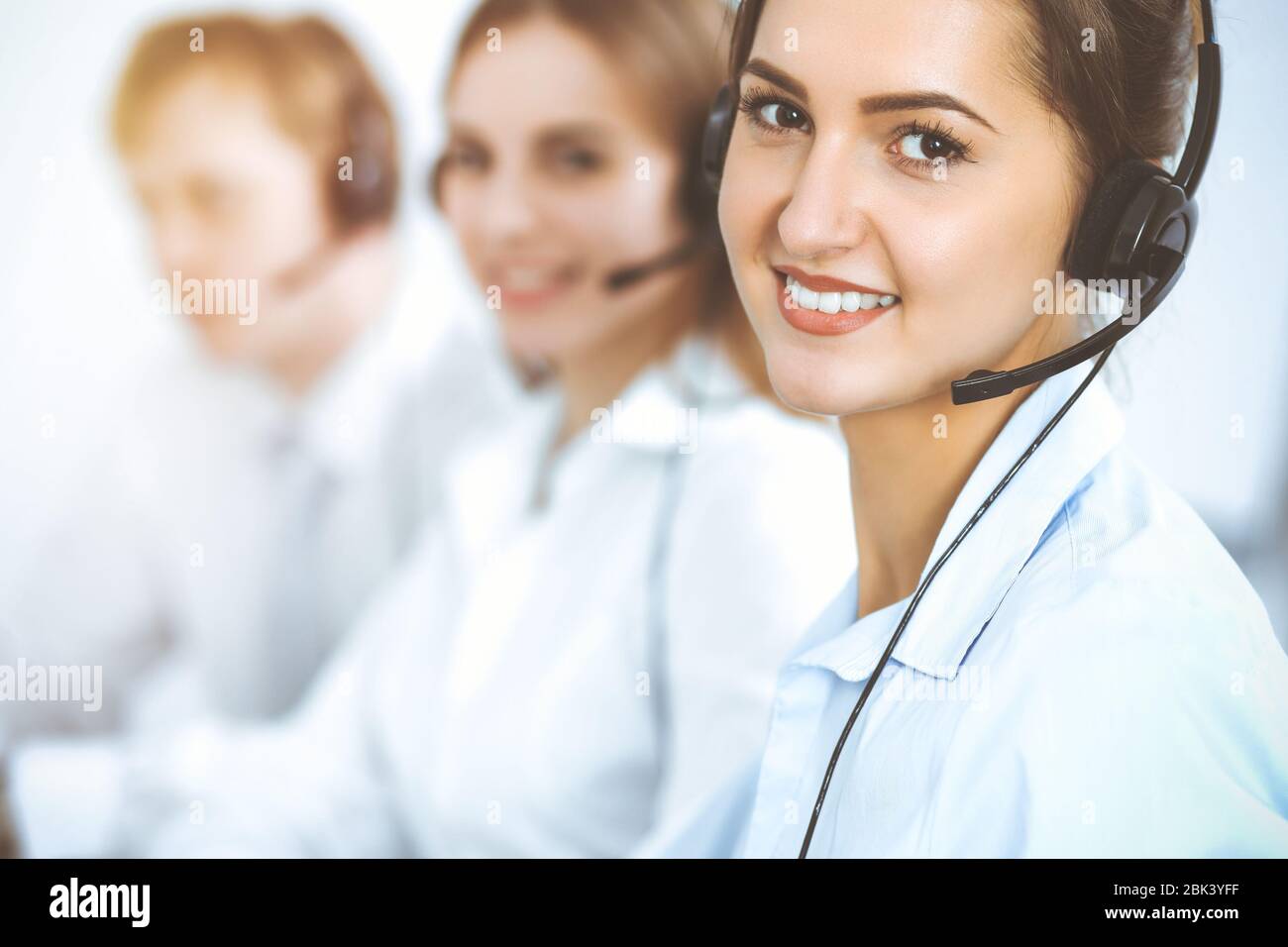 Call center. Focus on beautiful business woman in headset Stock Photo ...
