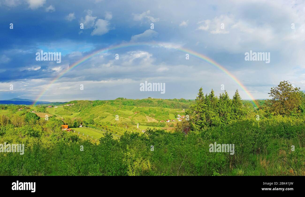 Spring rural rainbow landscape, view of green meadows and hills Stock ...