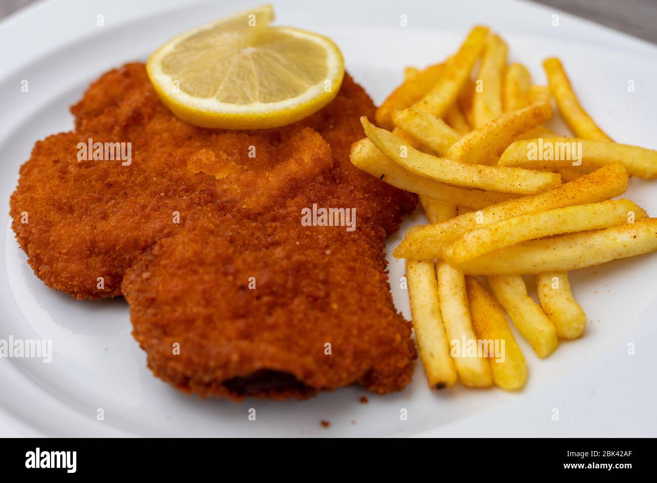 Breaded viennese schnitzel with french fries Stock Photo - Alamy