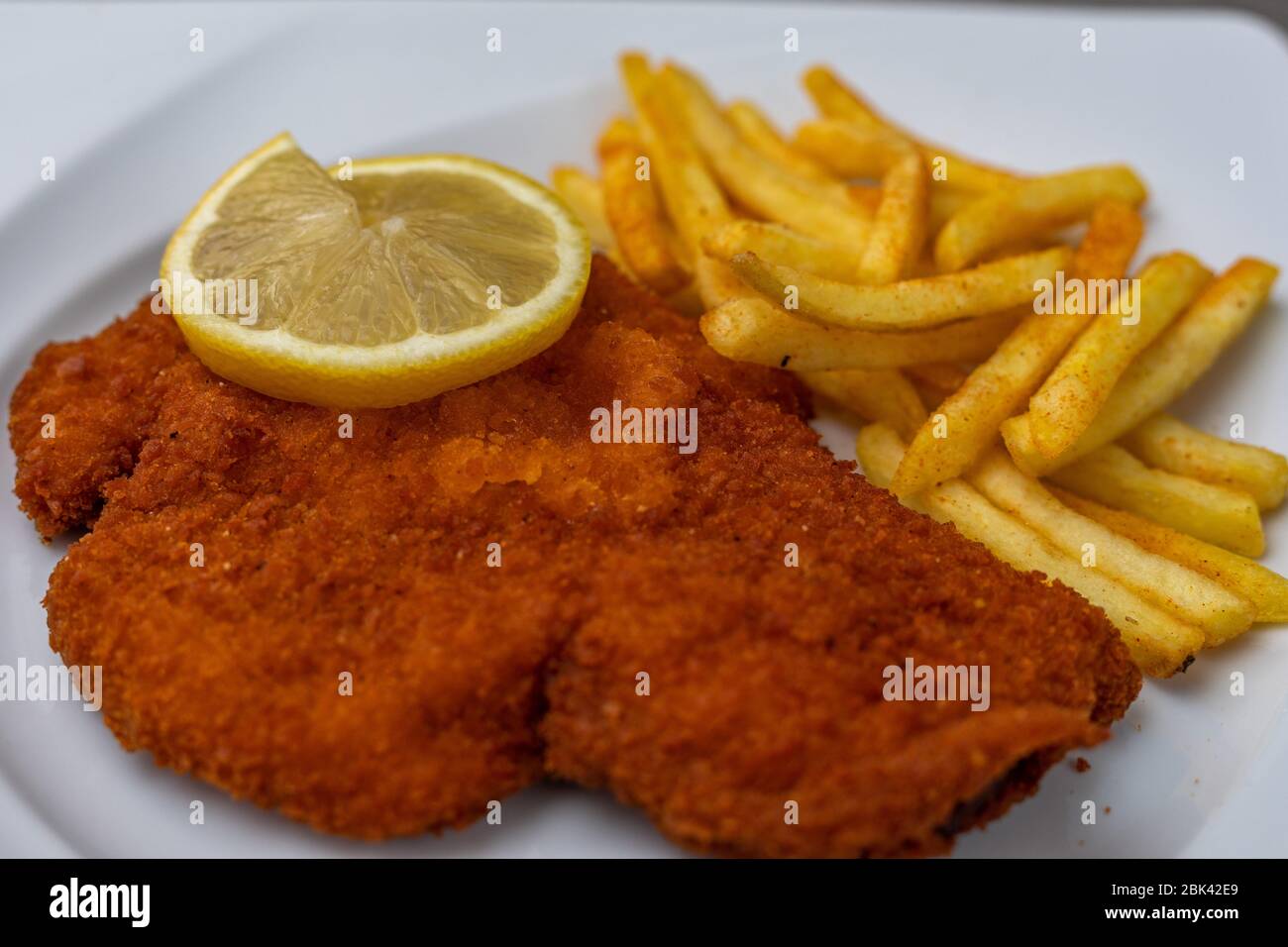 Breaded viennese schnitzel with french fries Stock Photo - Alamy