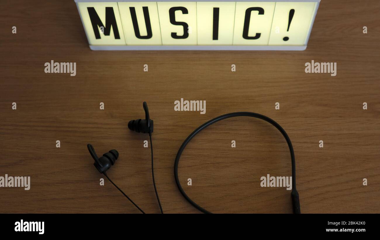 headphones on desk with bright sign Stock Photo - Alamy