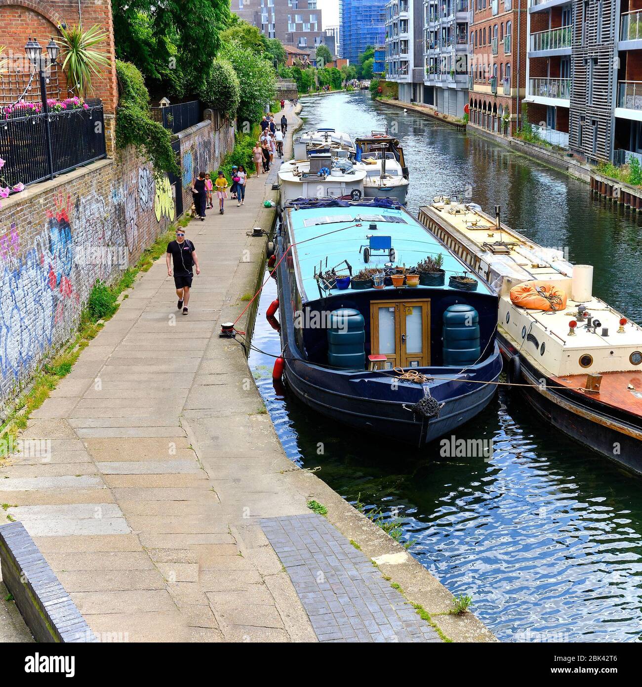 Canal pathway with people walking in Camden Town London Stock Photo - Alamy