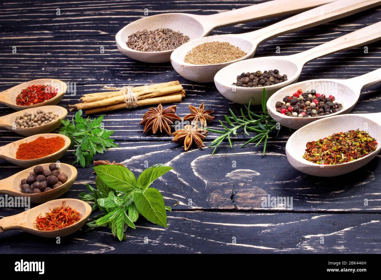 Colorful aromatic spices and herbs on an old oak wooden brown ...