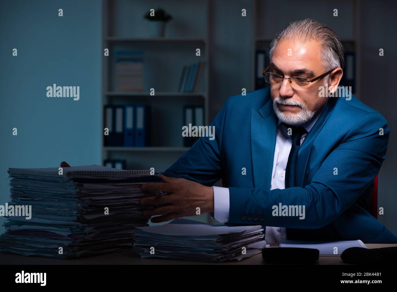 Old employee working late in the office Stock Photo - Alamy