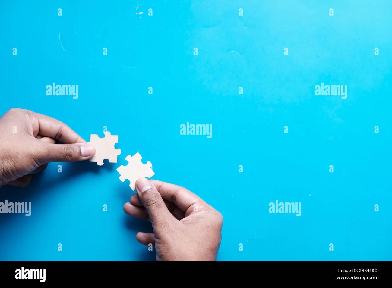 two hands trying to connect puzzle piece Stock Photo - Alamy