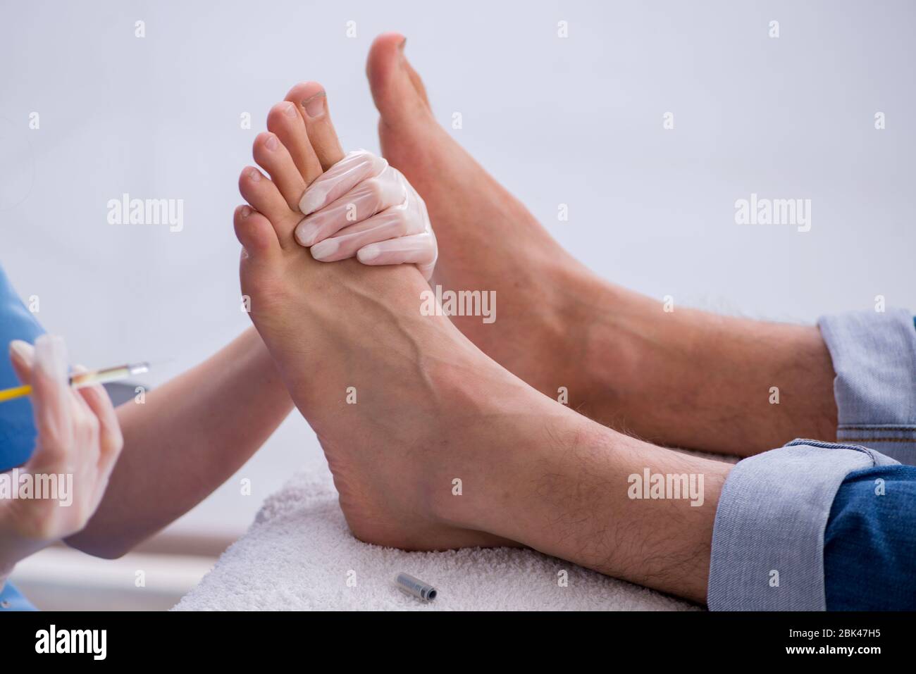 Podiatrist treating feet during the procedure Stock Photo - Alamy