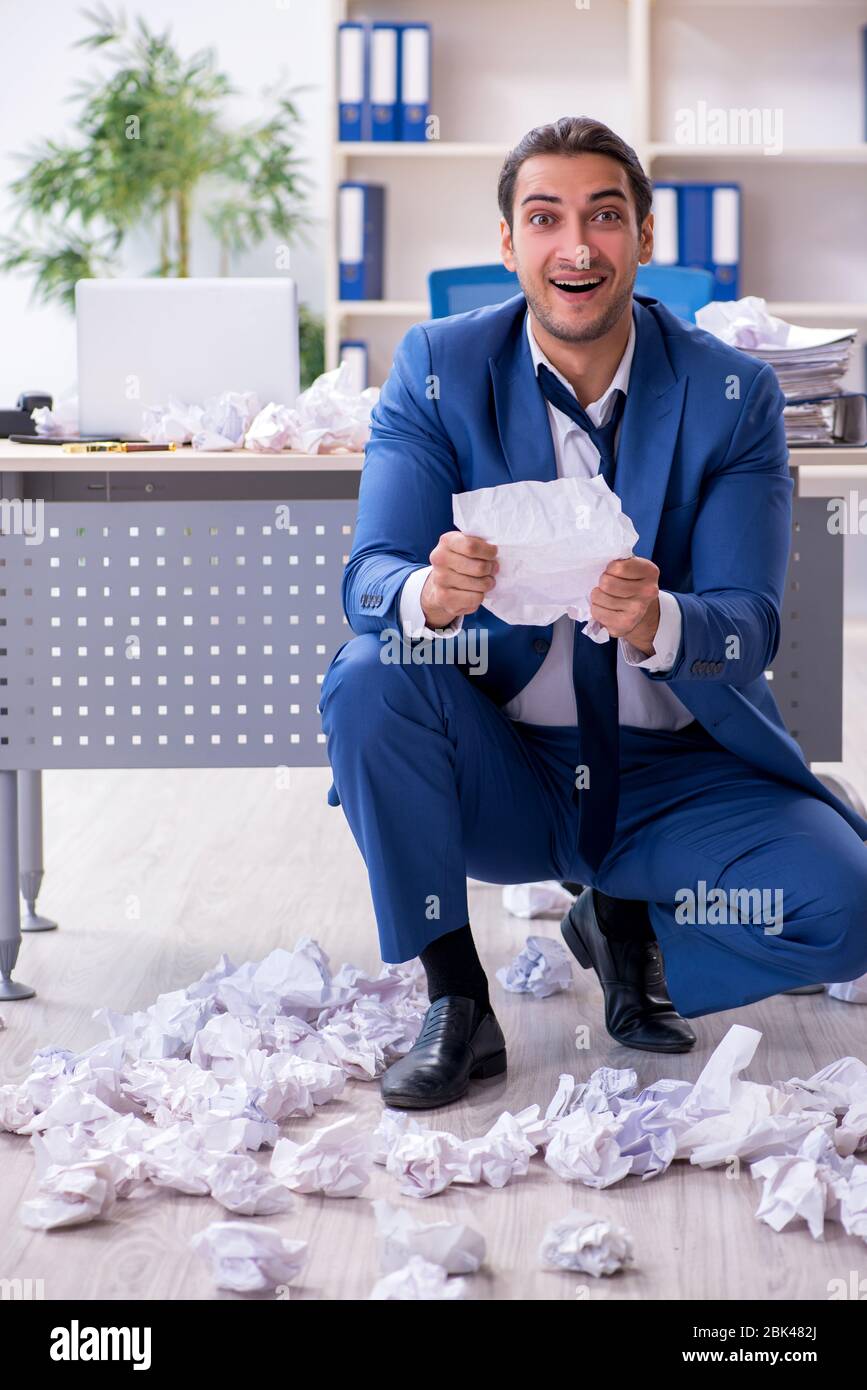 Businessman rejecting ideas with lots of papers Stock Photo - Alamy