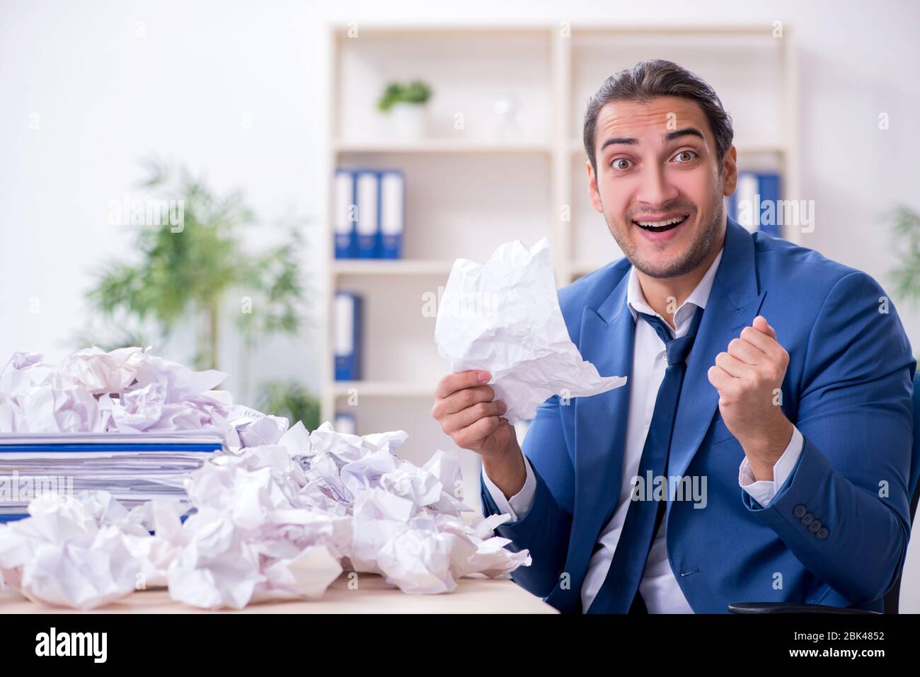 Businessman rejecting ideas with lots of papers Stock Photo - Alamy