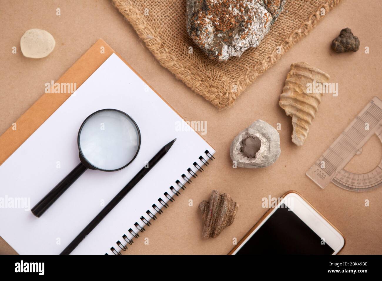 Geology rock laboratory. Stone samples, loop, notebook and mobile phome ...