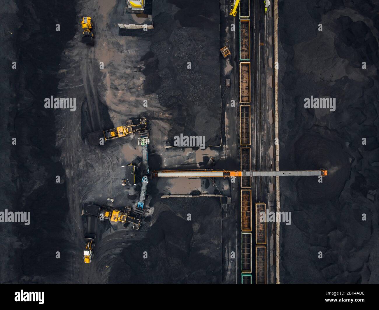 Loading coal anthracite mining in port on cargo tanker ship with crane ...