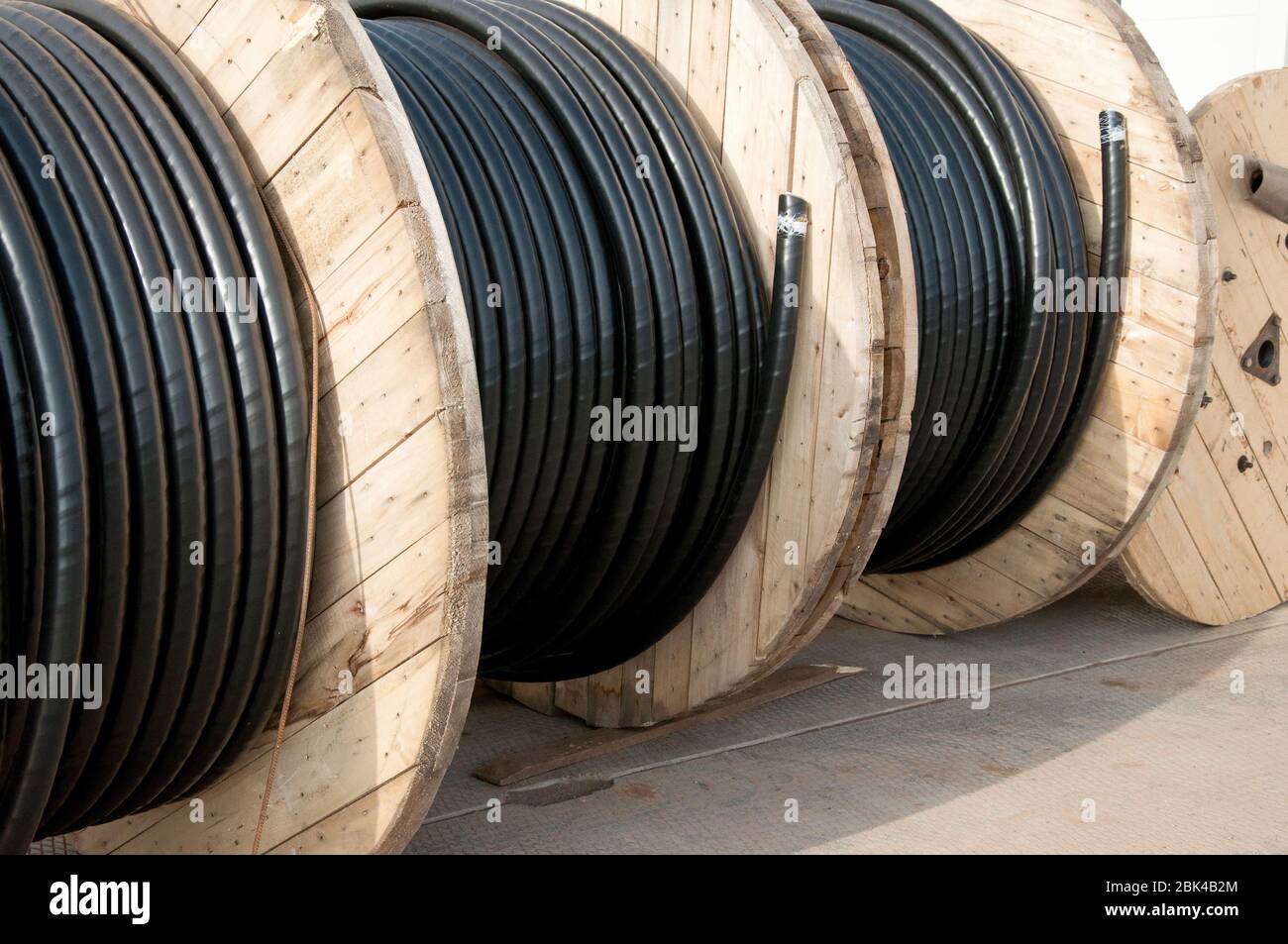 A bay of black Large diameter electric cable. Electric tools for ...