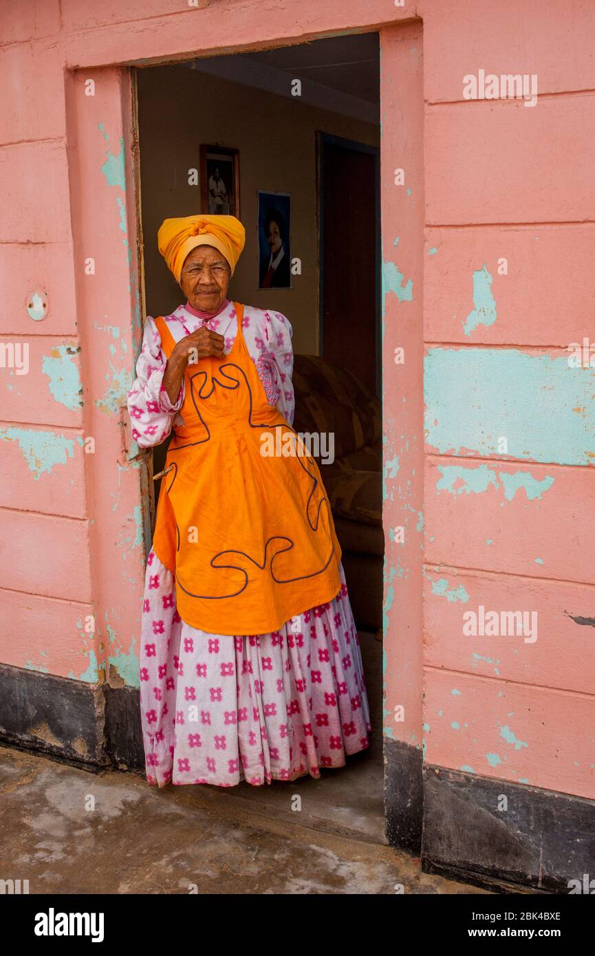 An old woman, the tribal chief of the Damara people, is standing in the ...