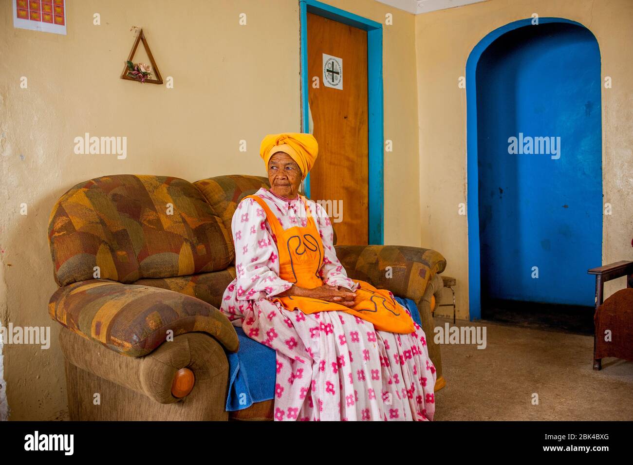 An old woman, the tribal chief of the Damara people, is sitting in the ...