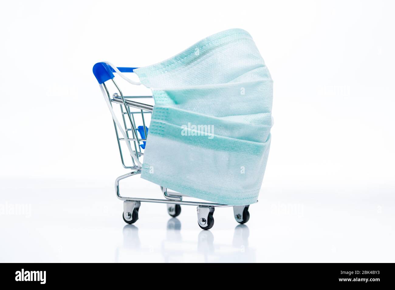 Shopping cart with protective medical mask against coronavirus. Safe ...