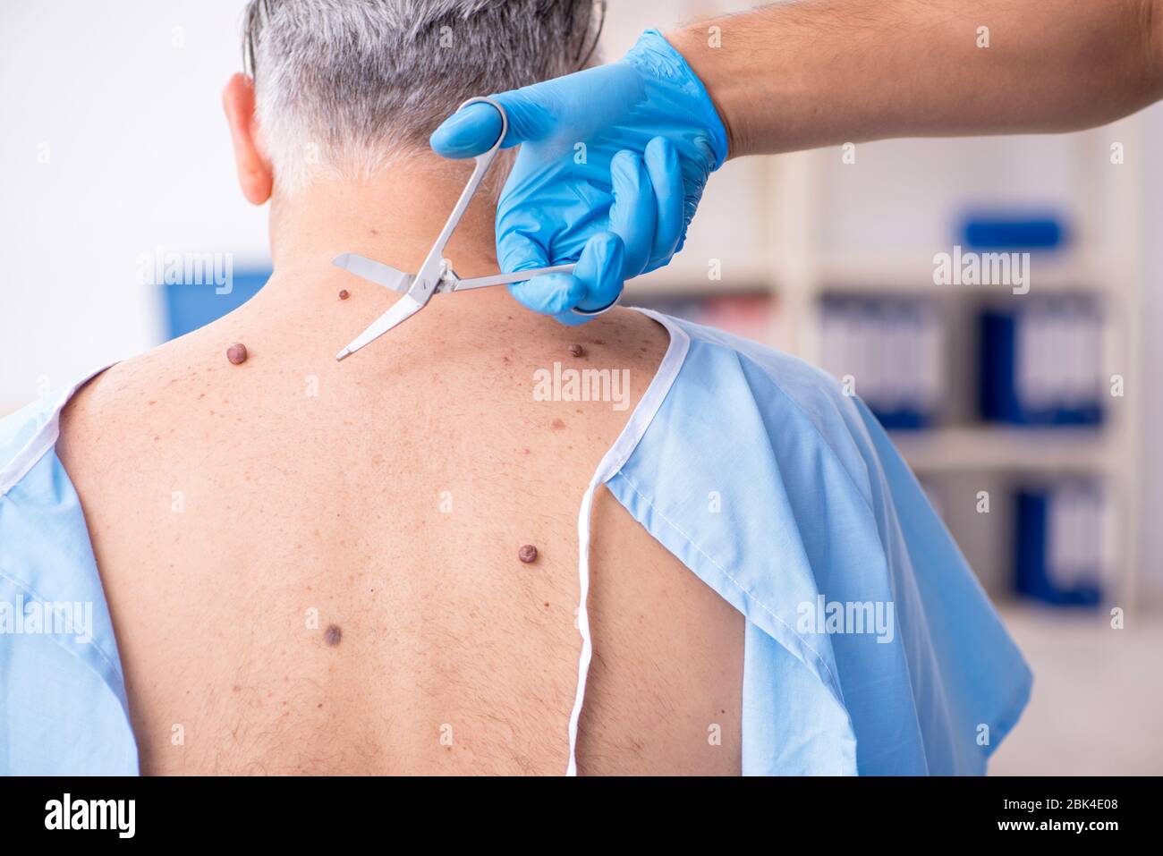 Old man visiting male doctor dermatologist Stock Photo - Alamy