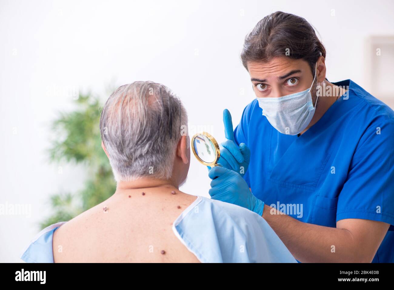 Old man visiting male doctor dermatologist Stock Photo - Alamy