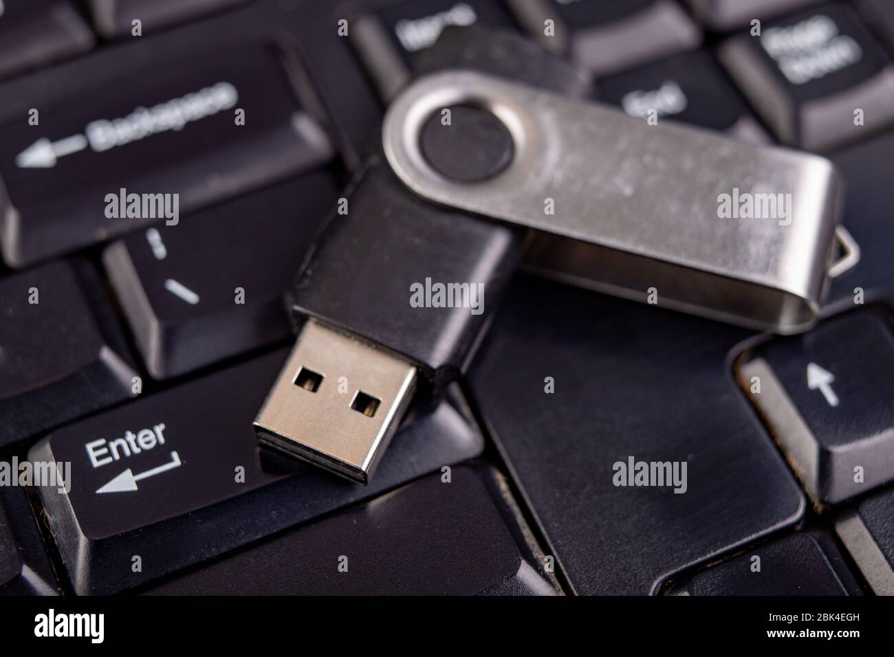 Black flash drive on a PC keyboard. Cache used to store temporary data ...