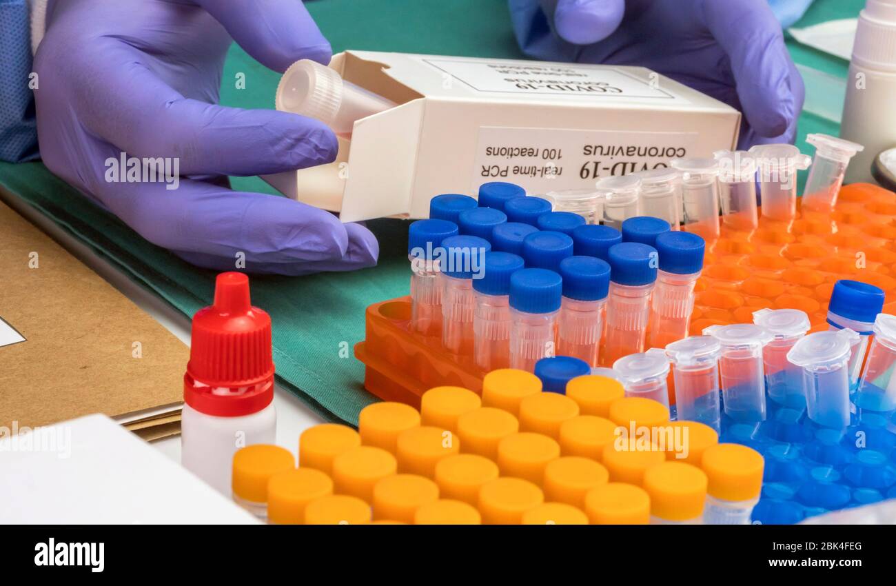 Nurse unpacking box with Covid-19 PCR kit in hospital warehouse ...